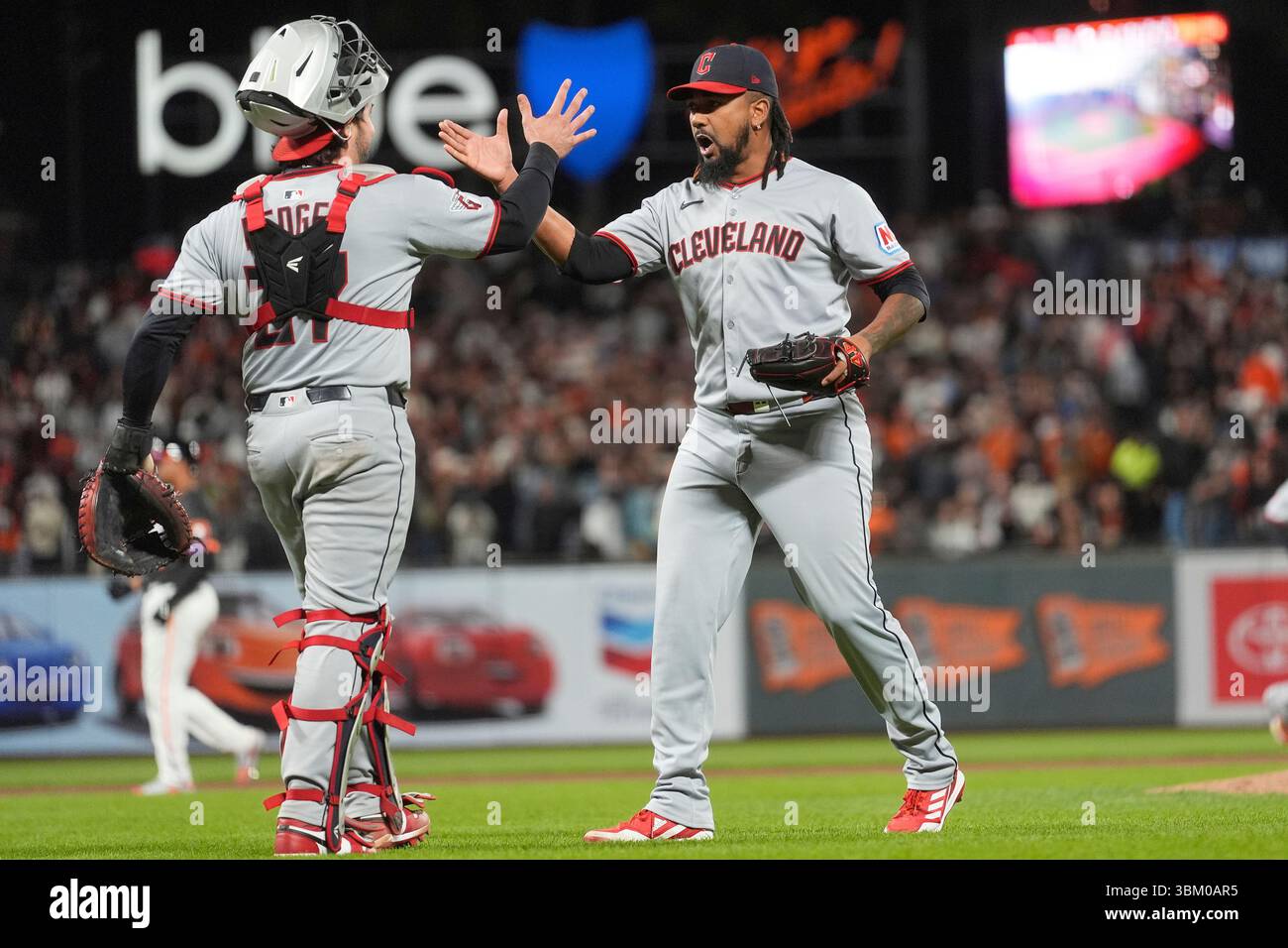Cleveland Guardians catcher Austin Hedges, left, celebrates with ...