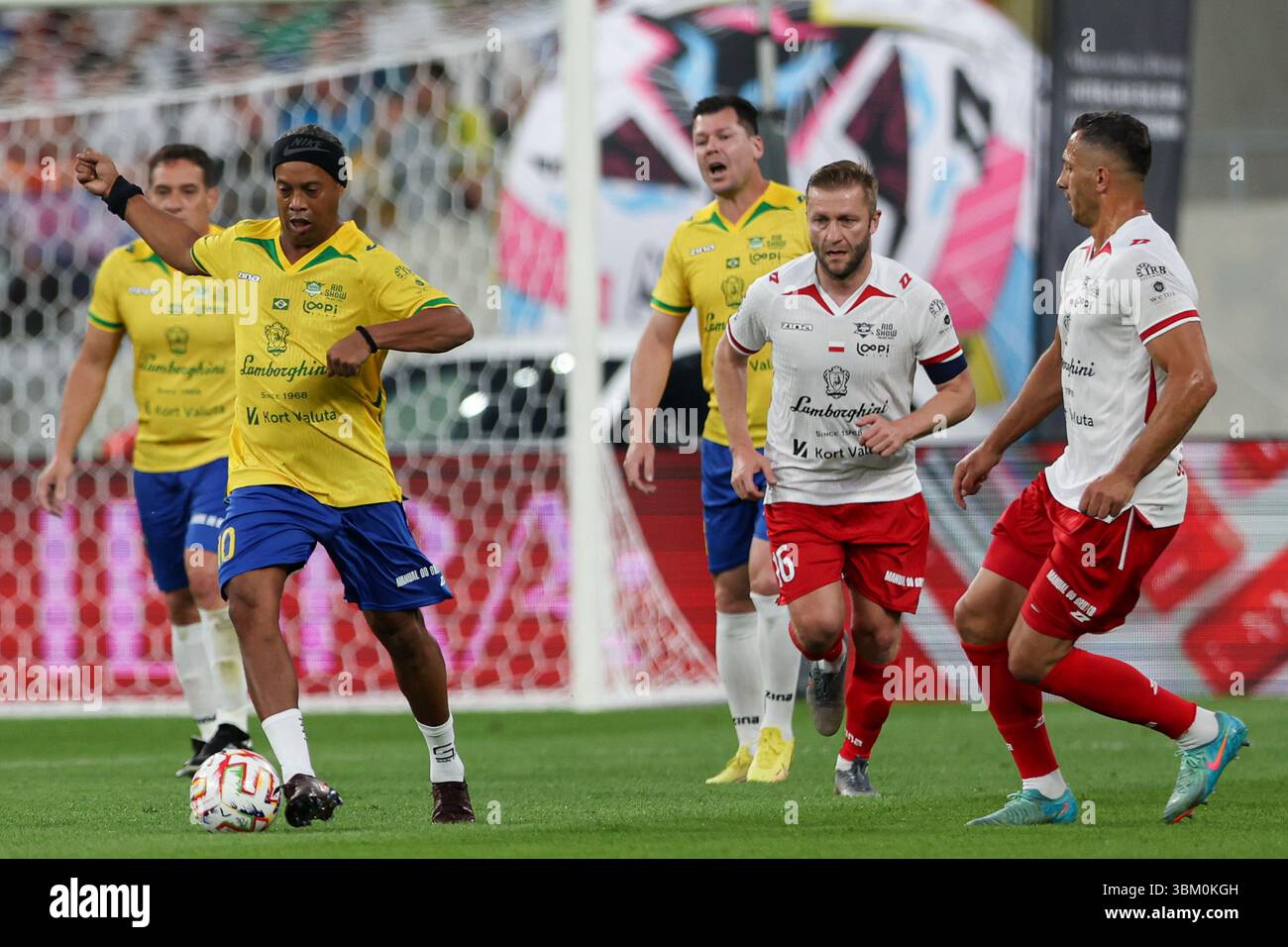 Chorzow, Poland. 21st June, 2025. Ronldinho Gaucho of Brazil (L), Jakub ...