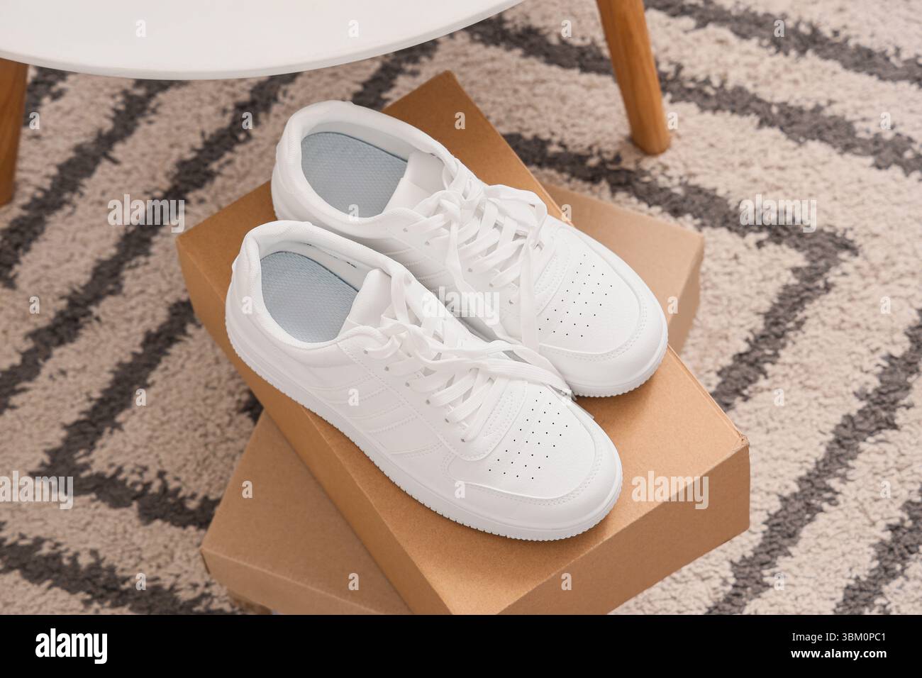 White sneakers with shoe boxes on carpet in room, closeup Stock Photo ...