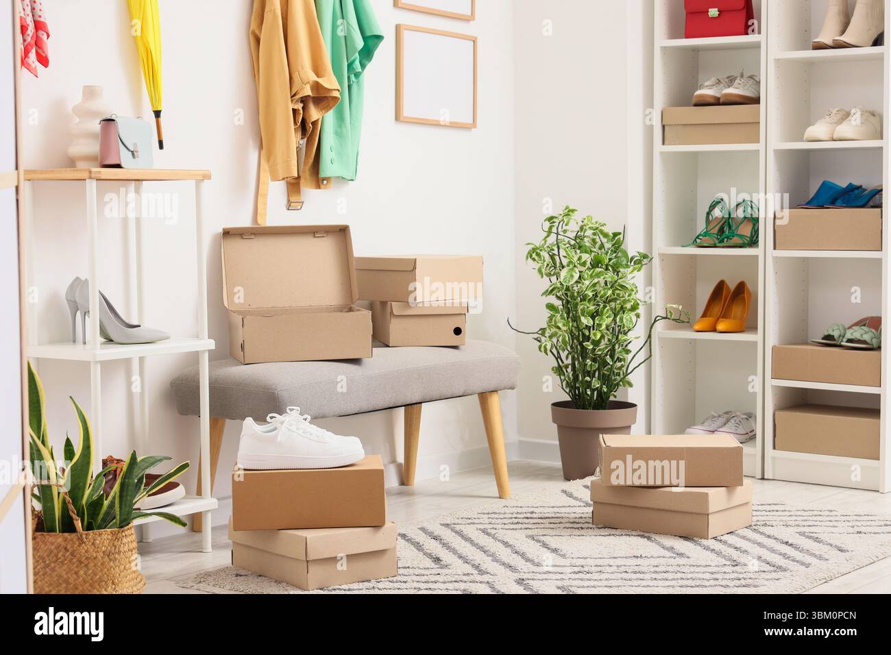 Soft bench with shoe boxes in wardrobe Stock Photo - Alamy