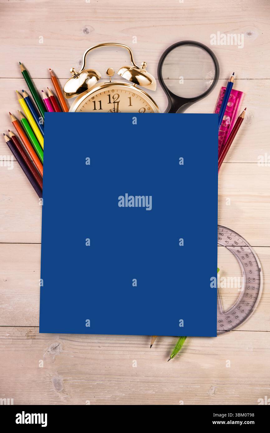 Students desk with blue page Stock Photo - Alamy
