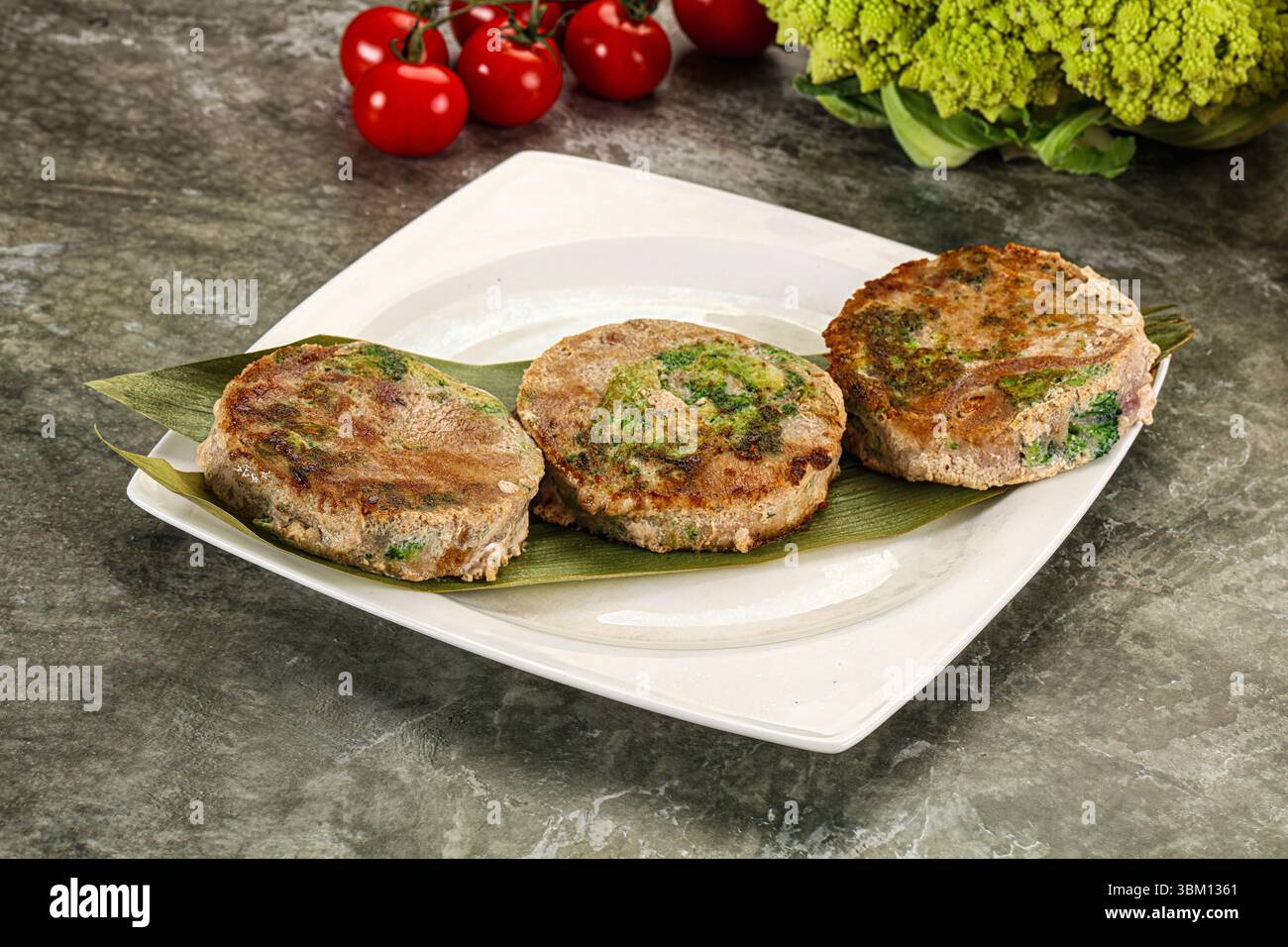 Roasted tuna medallion with broccoli cabbage Stock Photo - Alamy