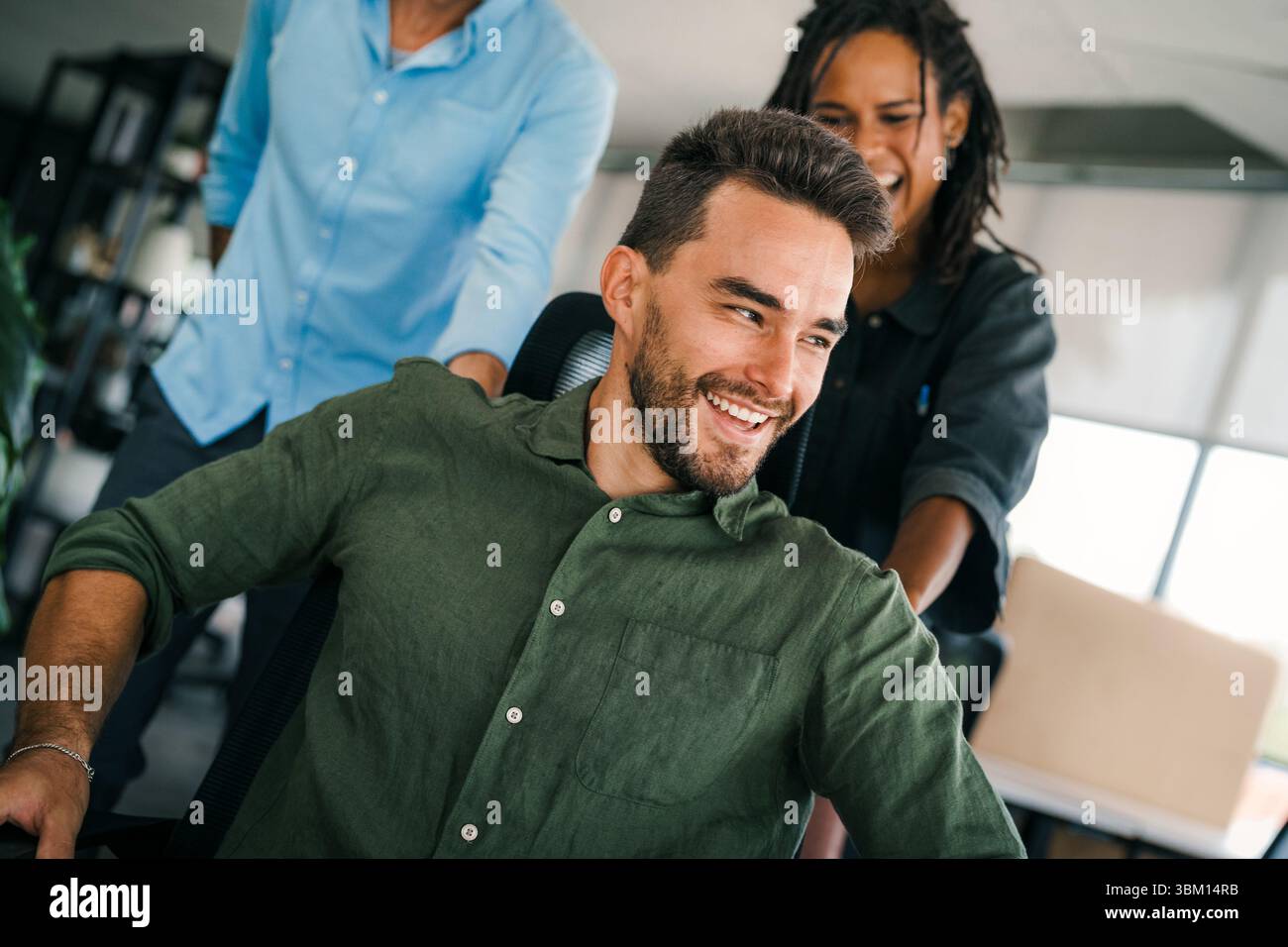Portrait of overjoyed young diverse employees workers in creative modern office. Team building ...