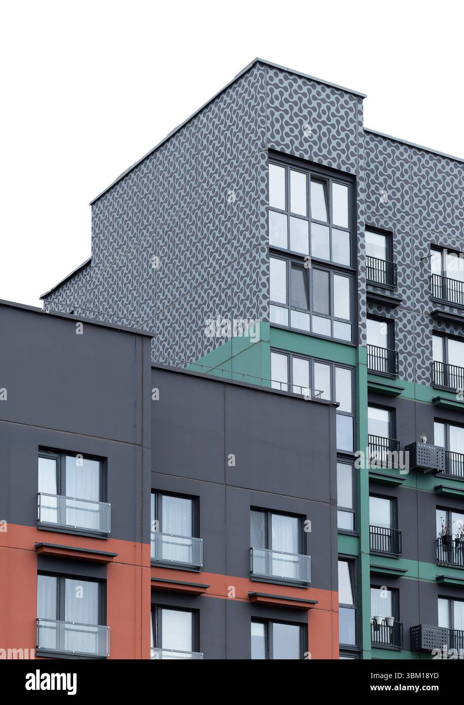 Building corner with red, gray, and green facade featuring geometric ...