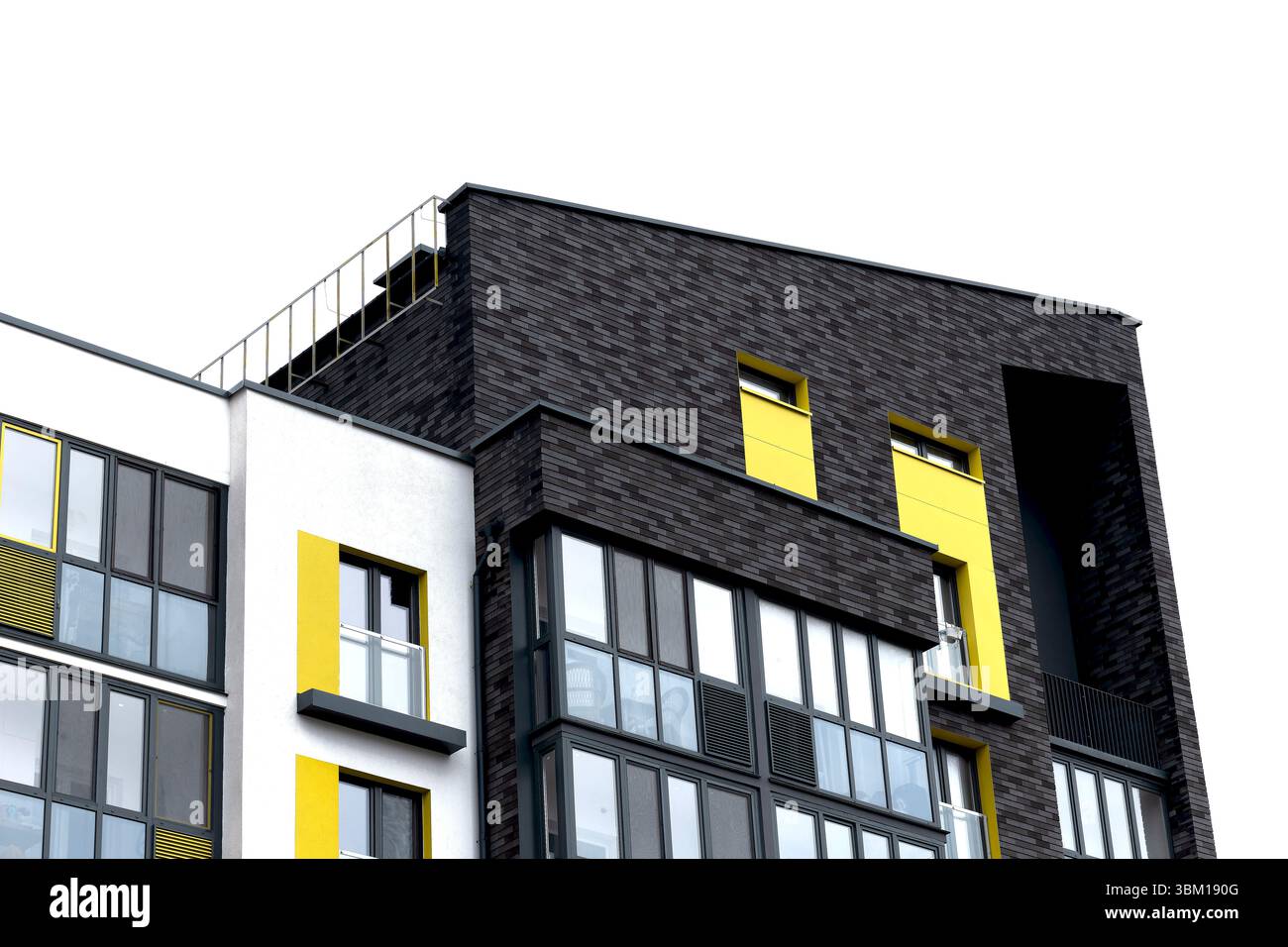 Building corner with yellow brick facade and geometric balconies ...