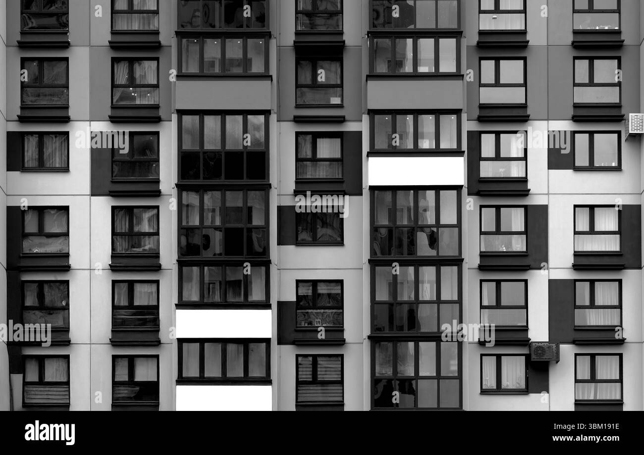 Building with black and white facade featuring windows and balconies in ...