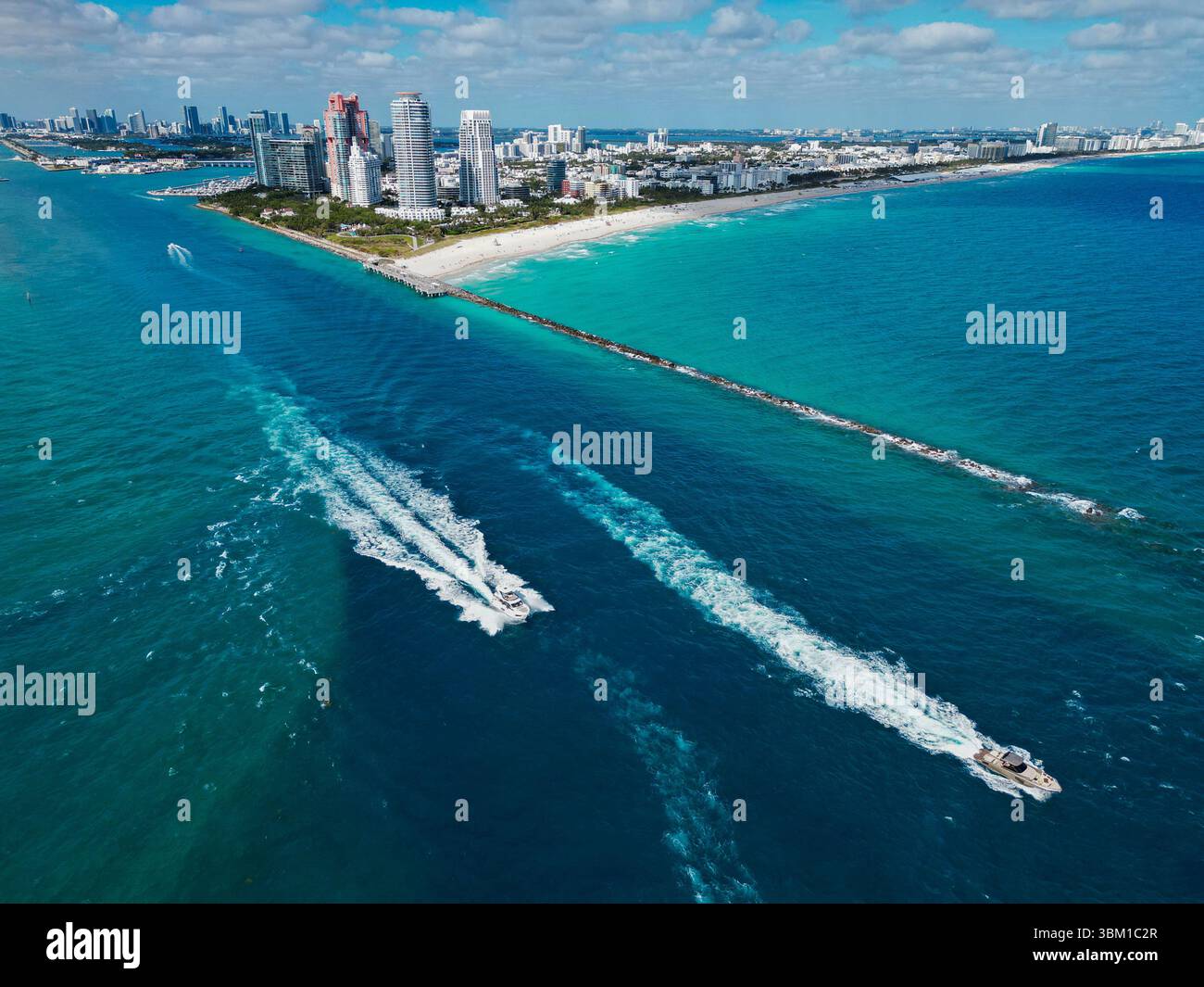 Yacht cruising near Miami Beach. Aerial view of boats on turquoise ...