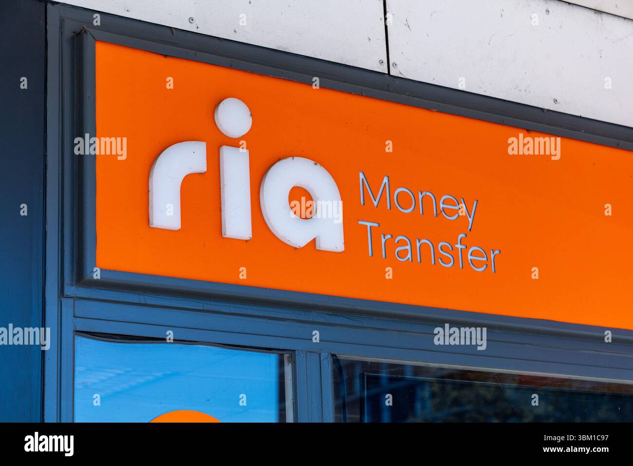 Orange Ria Money Transfer sign on a building facade, indicating financial services for sending ...