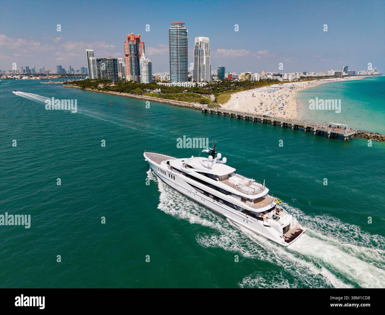 Yacht cruising near Miami skyline. Aerial view of boats on turquoise ...
