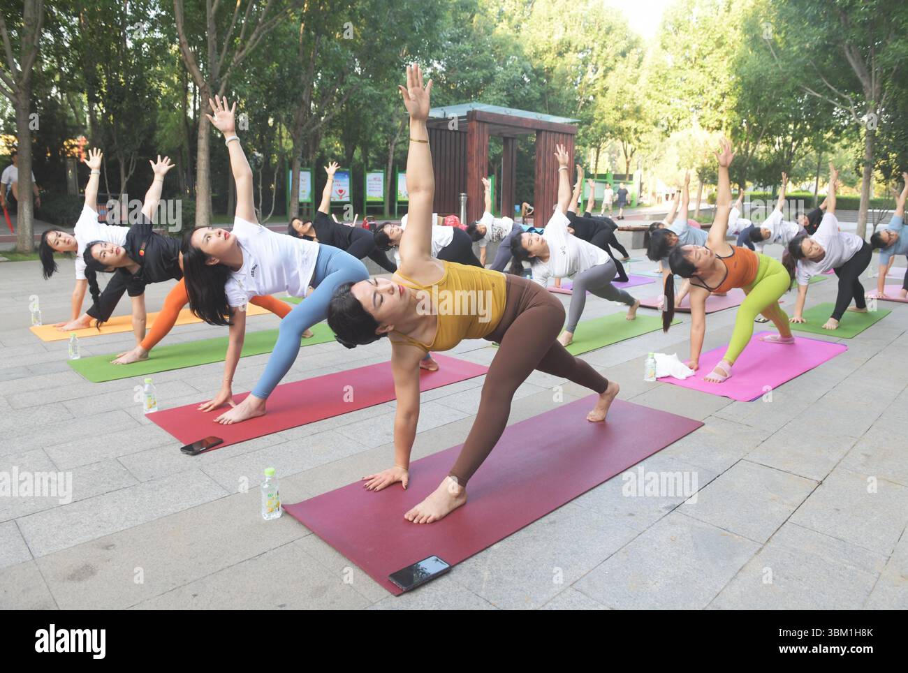 Yoga enthusiasts practice yoga in a park in Shijiazhuang City, north ...