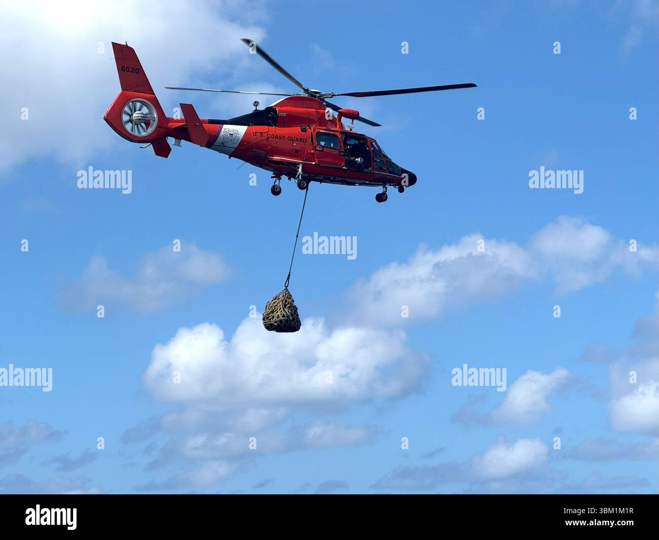 Coast Guard Cutter Campbell (WMEC 909) and an MH-65 Dolphin helicopter ...