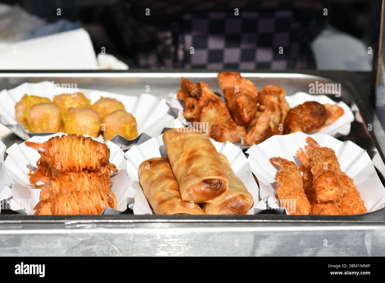 Different small fried Thai street food snacks like fried shrimp ...