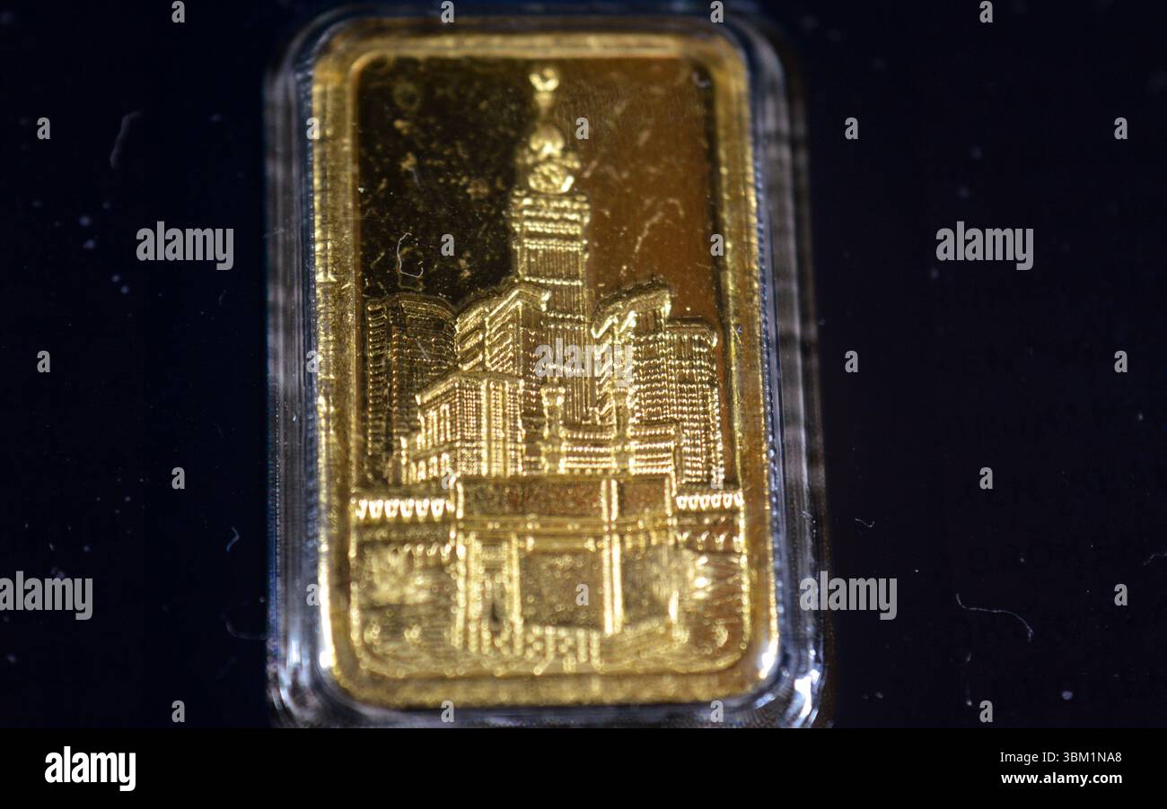 The clock towers of Makkah and the holy Kaaba on 24K karat pure yellow ...