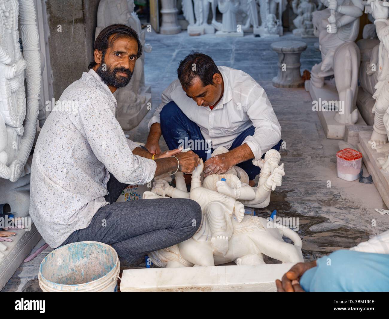 India, Varanasi, 16 Mar 2025. Artisans carve and polish white marble ...