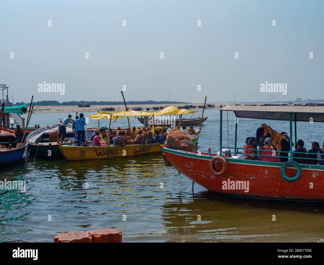 India, Kolkata, 16 Mar 2025. Pilgrims board an orange ferry on the ...