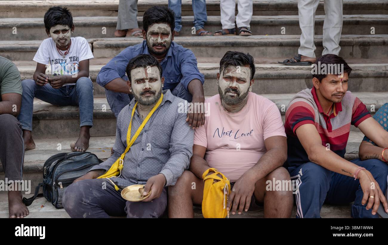 India, Varanasi, 14 Mar 2025. Group of Indian men sitting on the steps ...