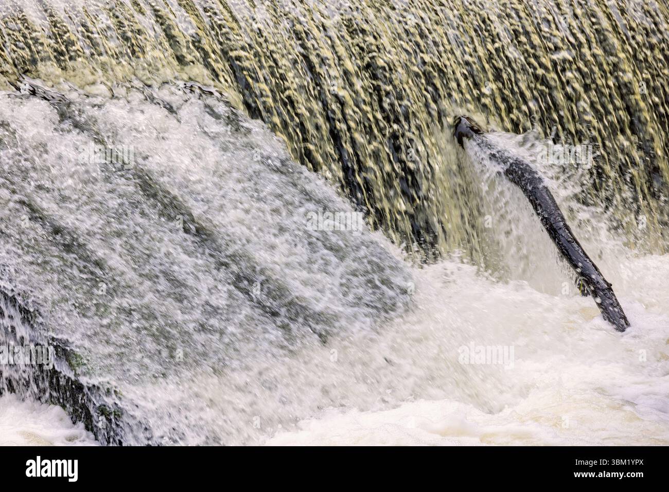 Waterfall with falling water at a dam Stock Photo - Alamy