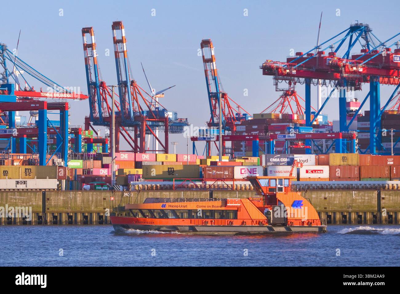 harbour ferry in front of the container gantry cranes of Burchardkai in ...