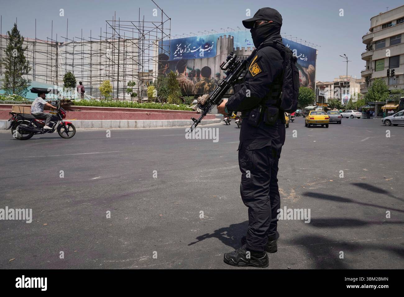 A member of Iran's Revolutionary Guard stands guard at Enqelab-e-Eslami ...