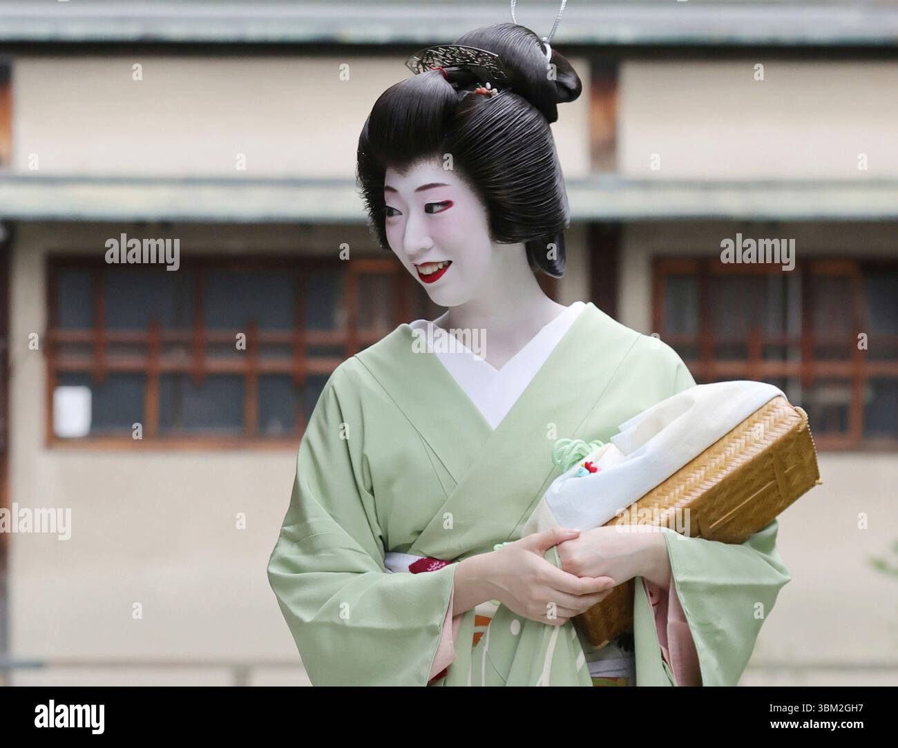 Geisha Taeno walks through the hanamachi in early summer, which is a ...