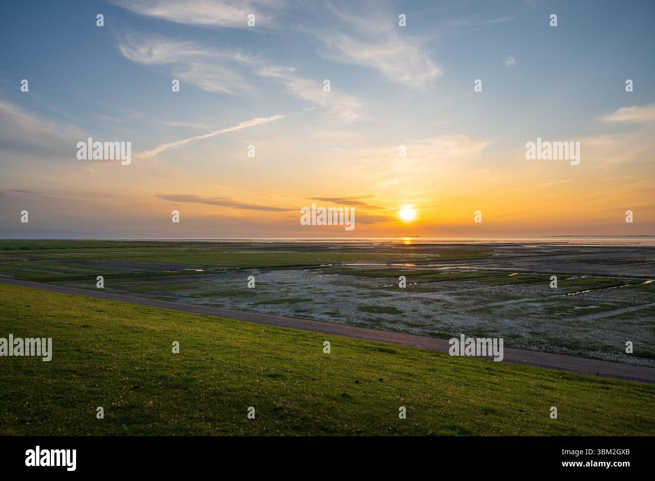 Sunset over mud flatlands in the North Sea Stock Photo - Alamy