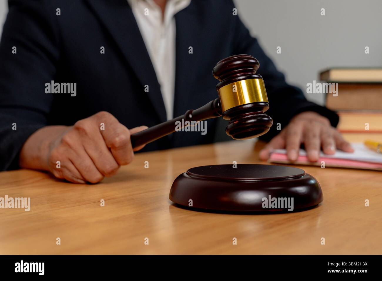 Selective focus on judge’s hand with gavel, symbolizing legal authority ...