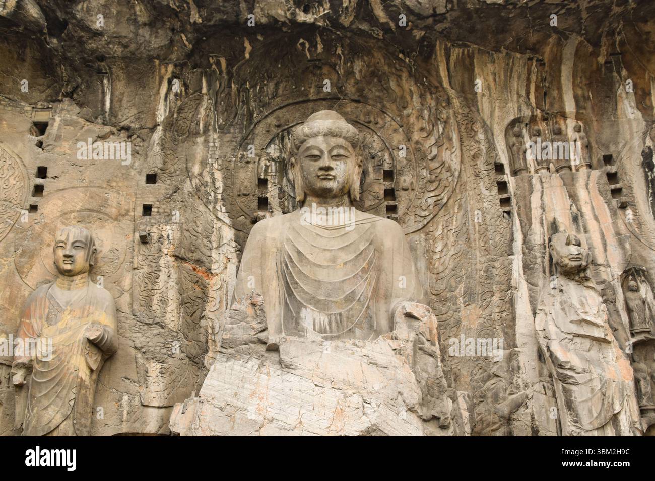 Ancient Buddhist statue carved into the rock face at Longmen Grottoes in Luoyang Stock Photo - Alamy