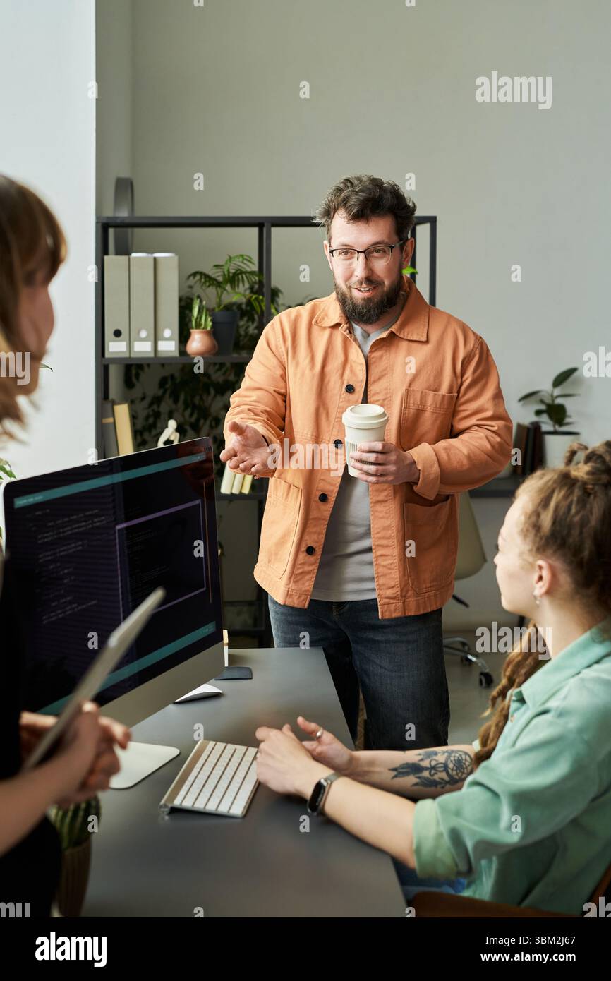 Man Explaining Neural Network Development to Colleagues Stock Photo - Alamy