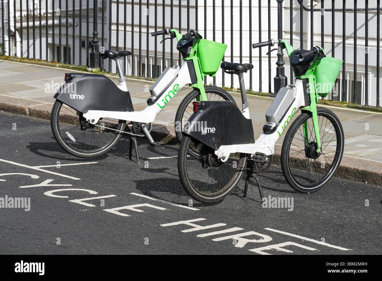 Lime electric bikes on a cycle hire parking space in London England ...