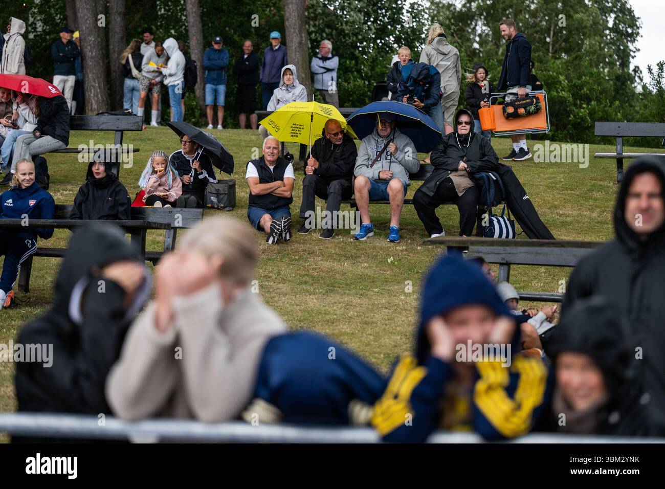 250624 Spectators with umbrellas during a training session with the Swedish women's national ...