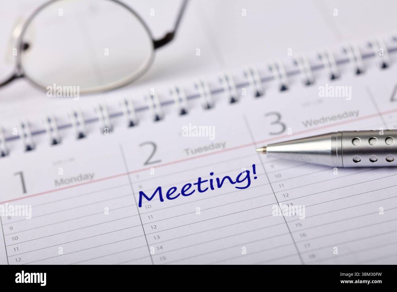 A detailed calendar page with a handwritten meeting reminder ...