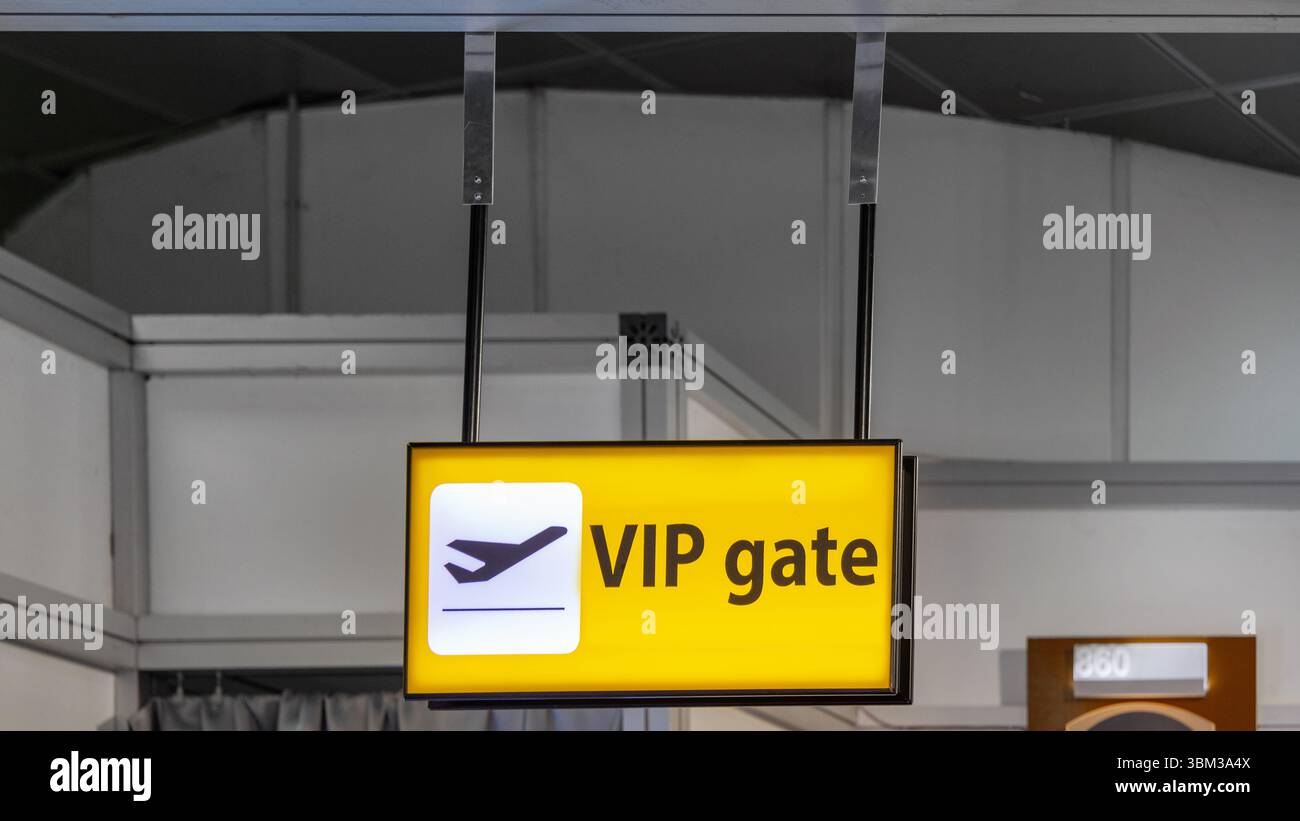 Illuminated Vip Gate Yellow Sign Hanging From Metal Beam at Airport ...