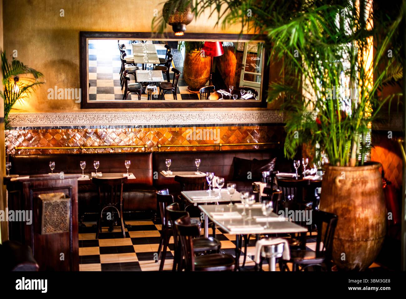 Interior of a typical Moroccan restaurant with mirrors and tables set ...