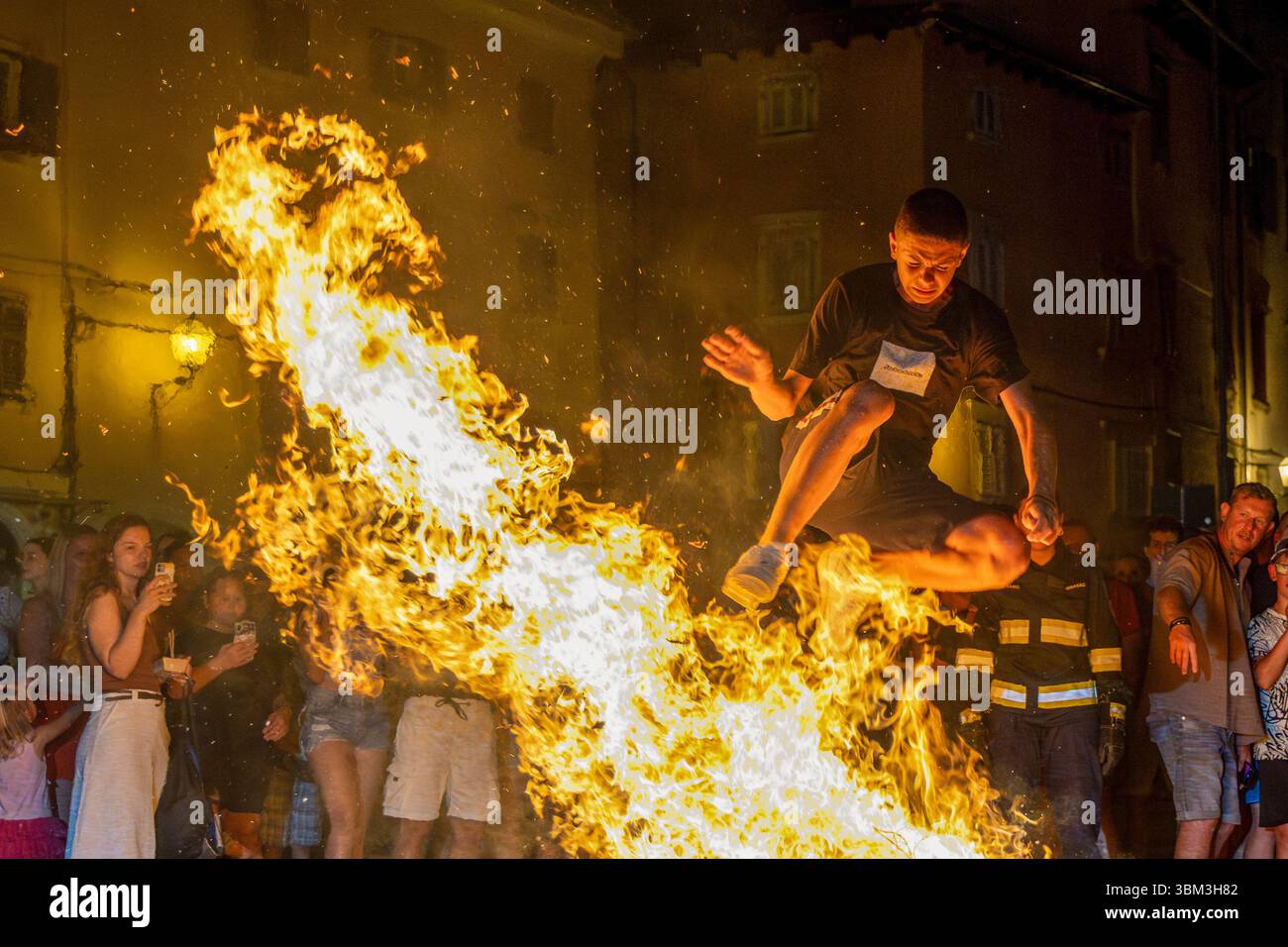 People jump over fire during St. John's bonfires celebration in Vodnjan ...