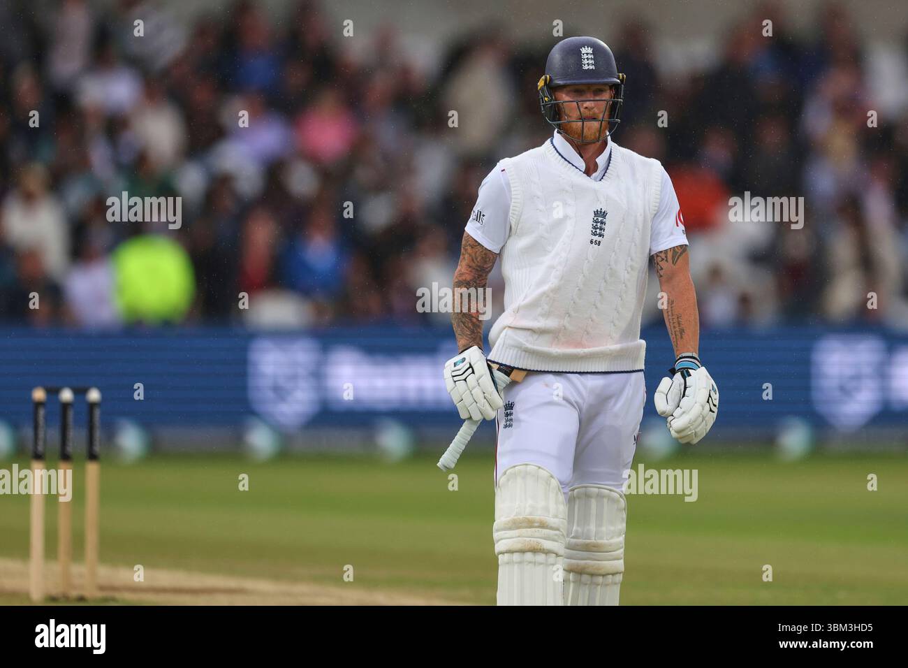 England captain Ben Stokes leaves the field at tea as it rains on day ...