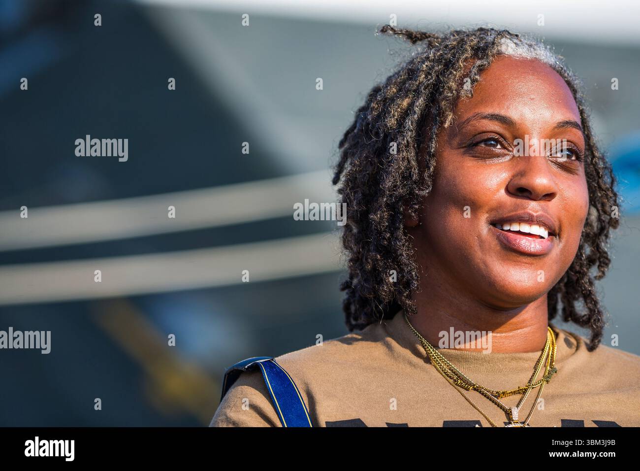 Latoya Savoy stands in front of the USS Gerald R. Ford aircraft carrier ...