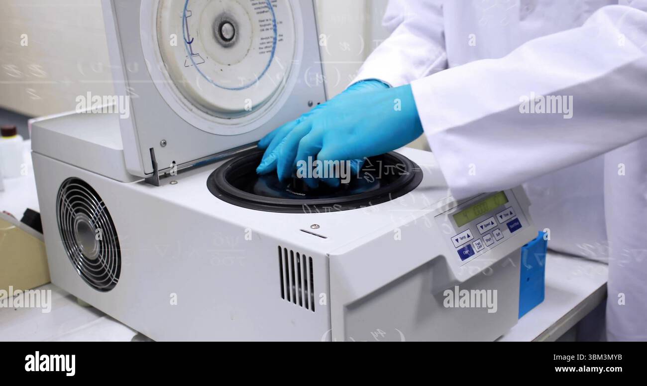 Technician wearing white lab coat loading sample tubes into benchtop ...