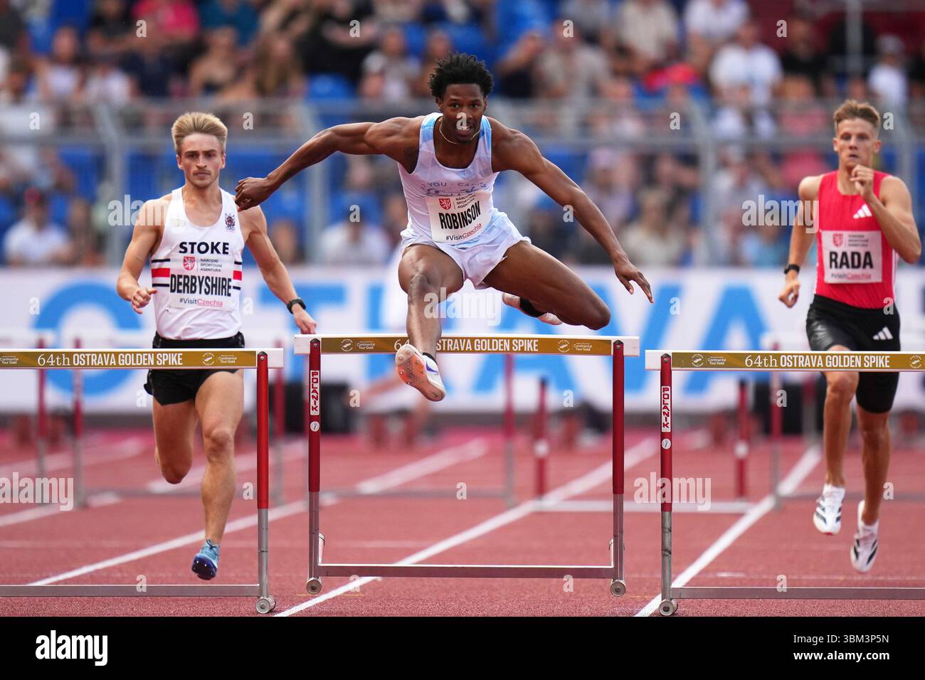 Chris Robinson, of the United States, clears a hurdle on his way to ...