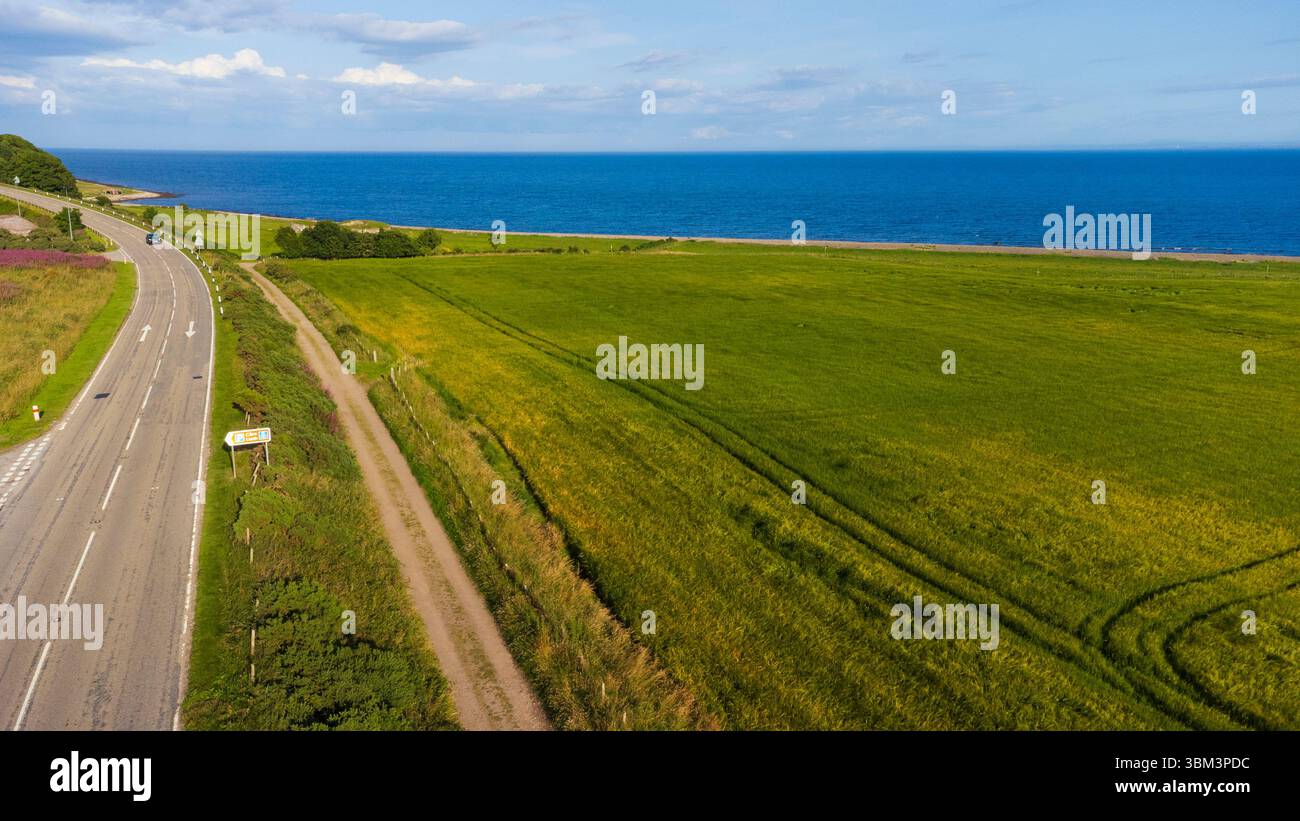 Aerial view of the A9 road near Golspie in the Scottish Highlands of ...