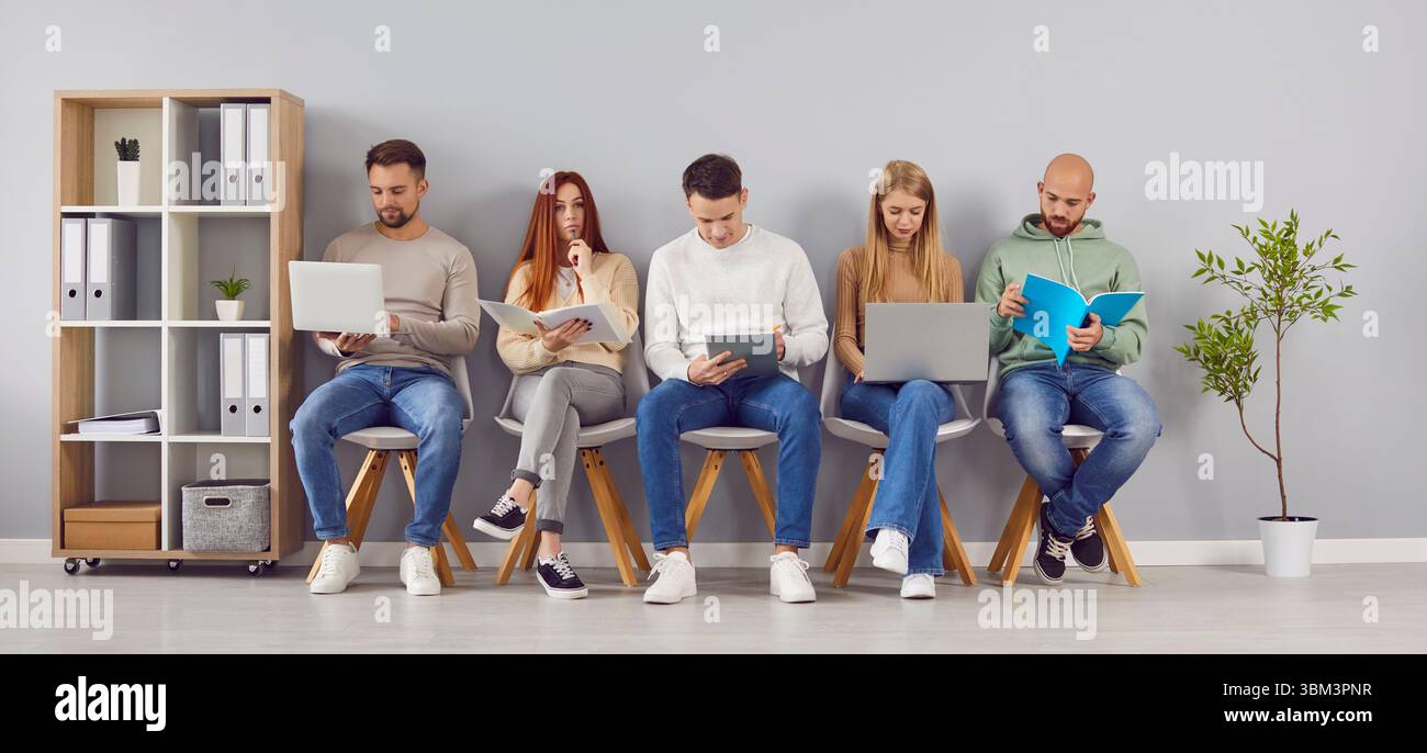 Group of young smart people office lobby chair row sitting, working ...