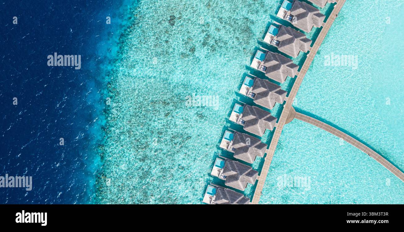 Stunning aerial top view of Maldives luxury water villas and bungalows ...