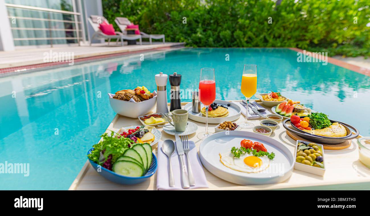 Relaxing tropical morning with floating breakfast in infinity pool at ...