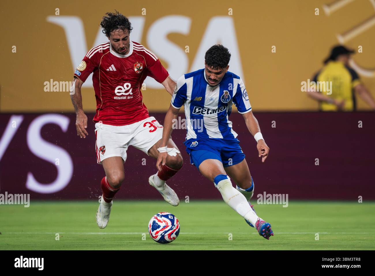 Mohamed Hany of Al Ahly FC competes for th ball with William Gomes of ...