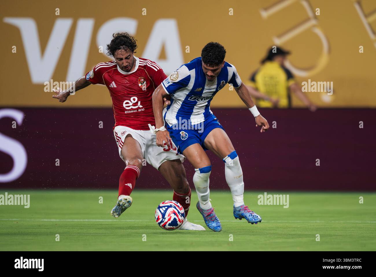 Mohamed Hany of Al Ahly FC competes for th ball with William Gomes of ...