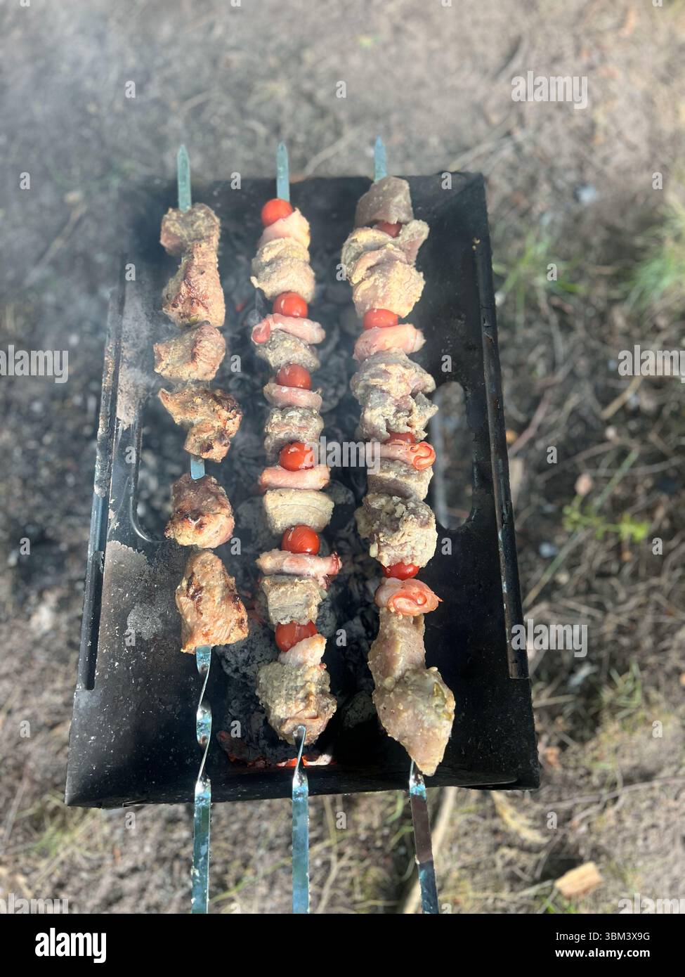 Sizzling skewers over charcoal fire hi-res stock photography and images ...