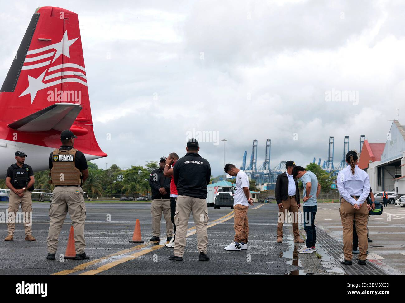 Colombian migrants line up to board a repatriation flight bound for ...