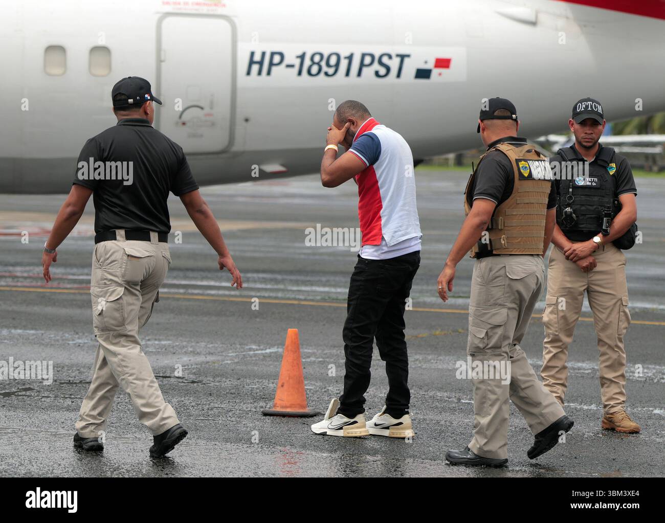 A Colombian migrant waits to board a repatriation flight bound for his ...