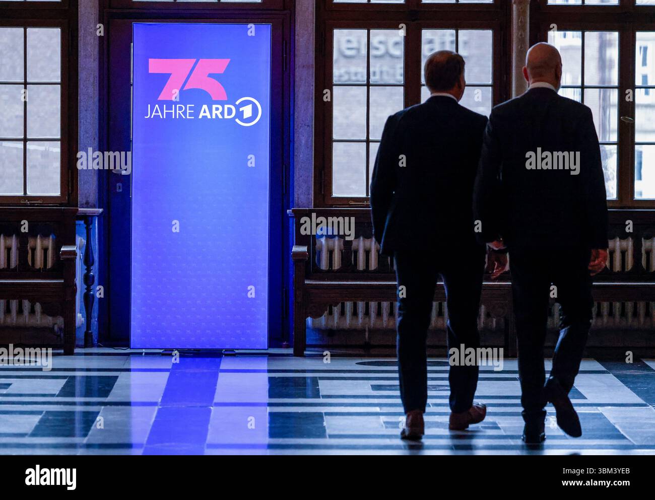 Bremen, Germany. 24th June, 2025. Two guests walk next to an ARD logo ...