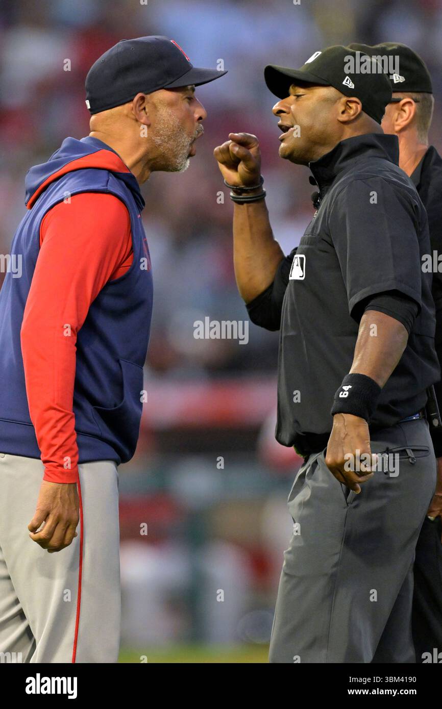 Boston Red Sox manager Alex Cora, left, argues with umpire Alan Porter ...