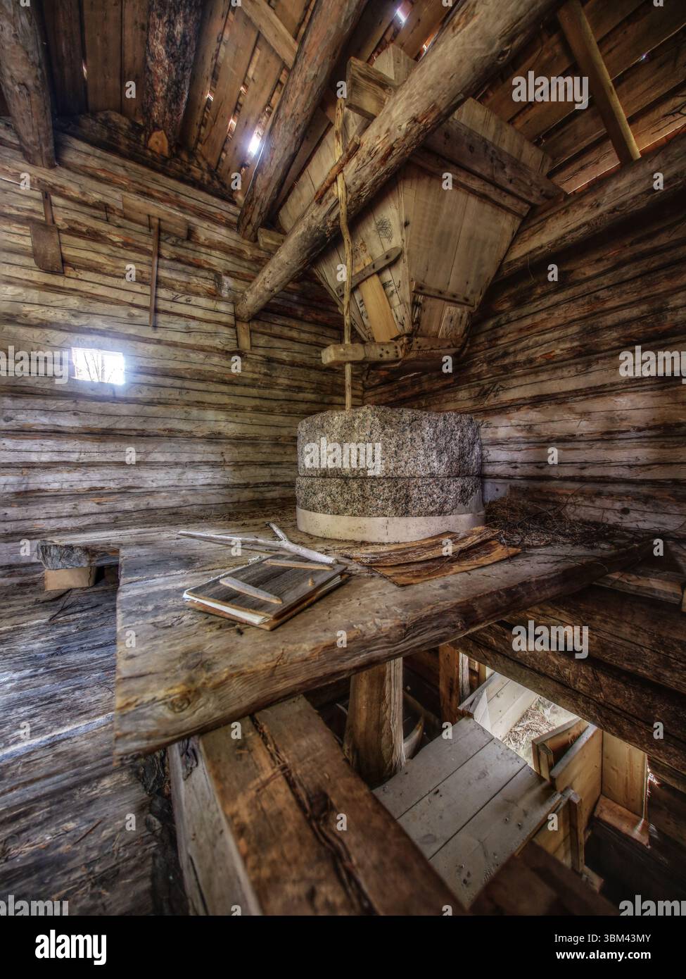 Wooden mill interior with stone grinder and rustic carpentry details ...